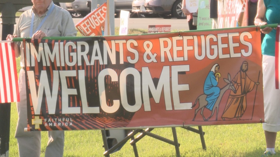 Dozens holding signs in opposition to immigration policy | whas11.com