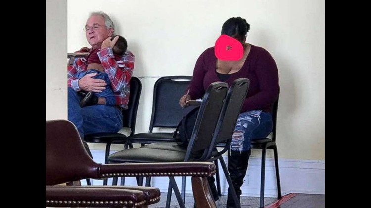 The story behind the viral photo of man cradling baby that's been ...