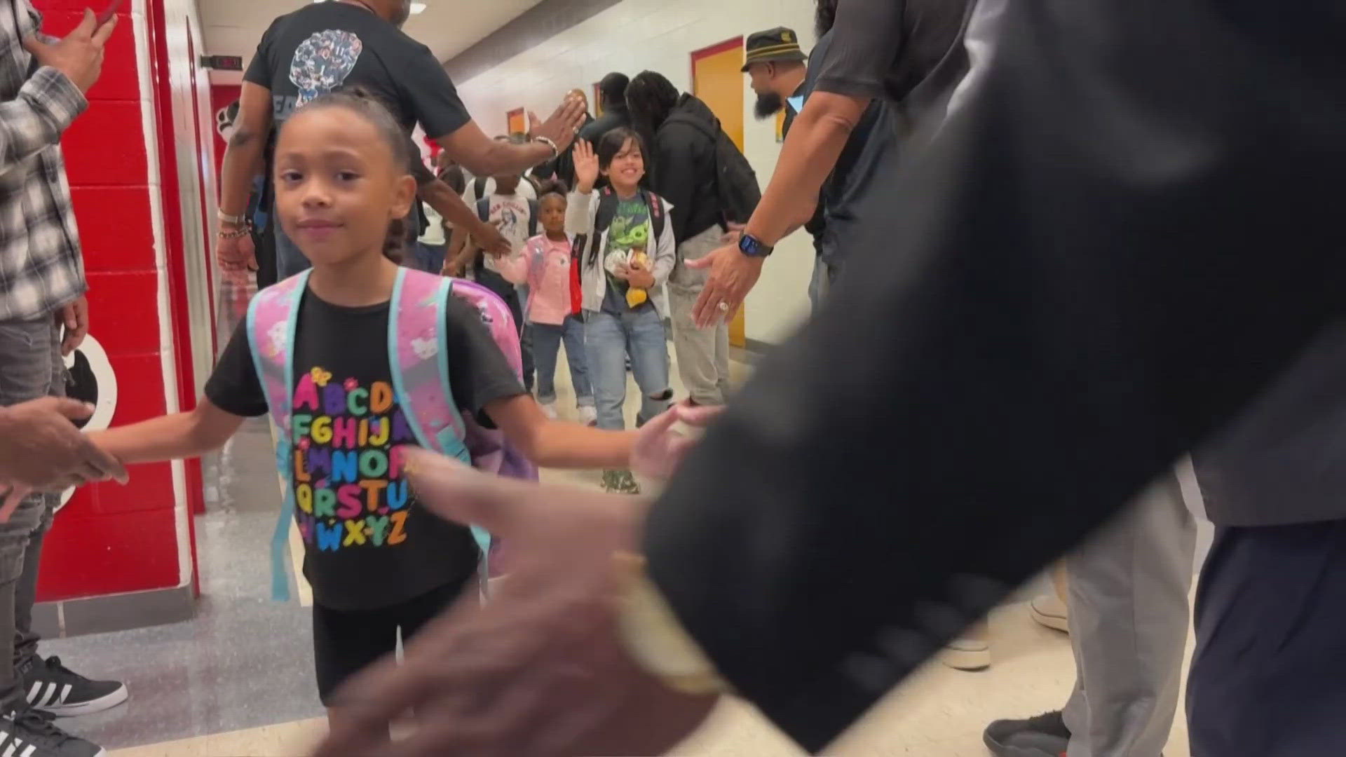 The Flash Dads welcoming Louisville elementary schoolers to school ...